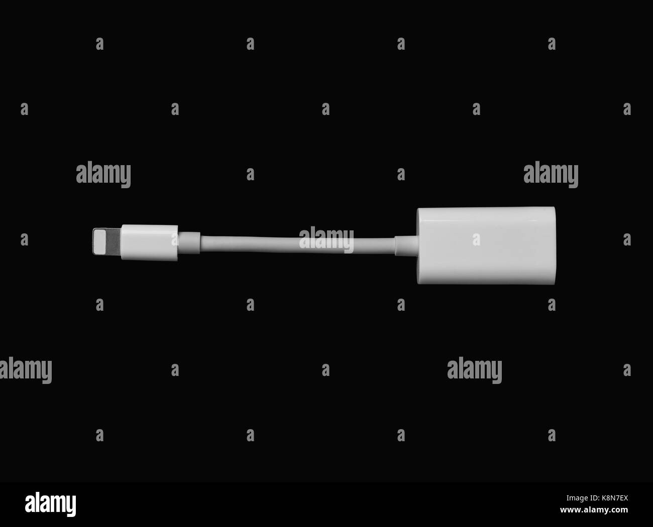 White adapter for mobile phone on black background Stock Photo - Alamy