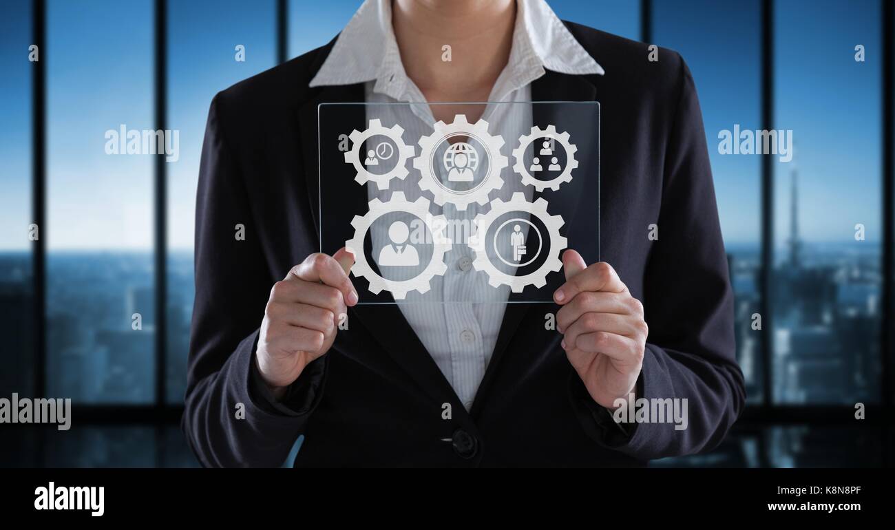 Digital composite of Business woman interacting with people in cogs ...