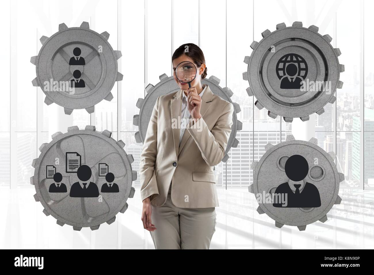 Digital composite of Business woman standing against people in cogs ...