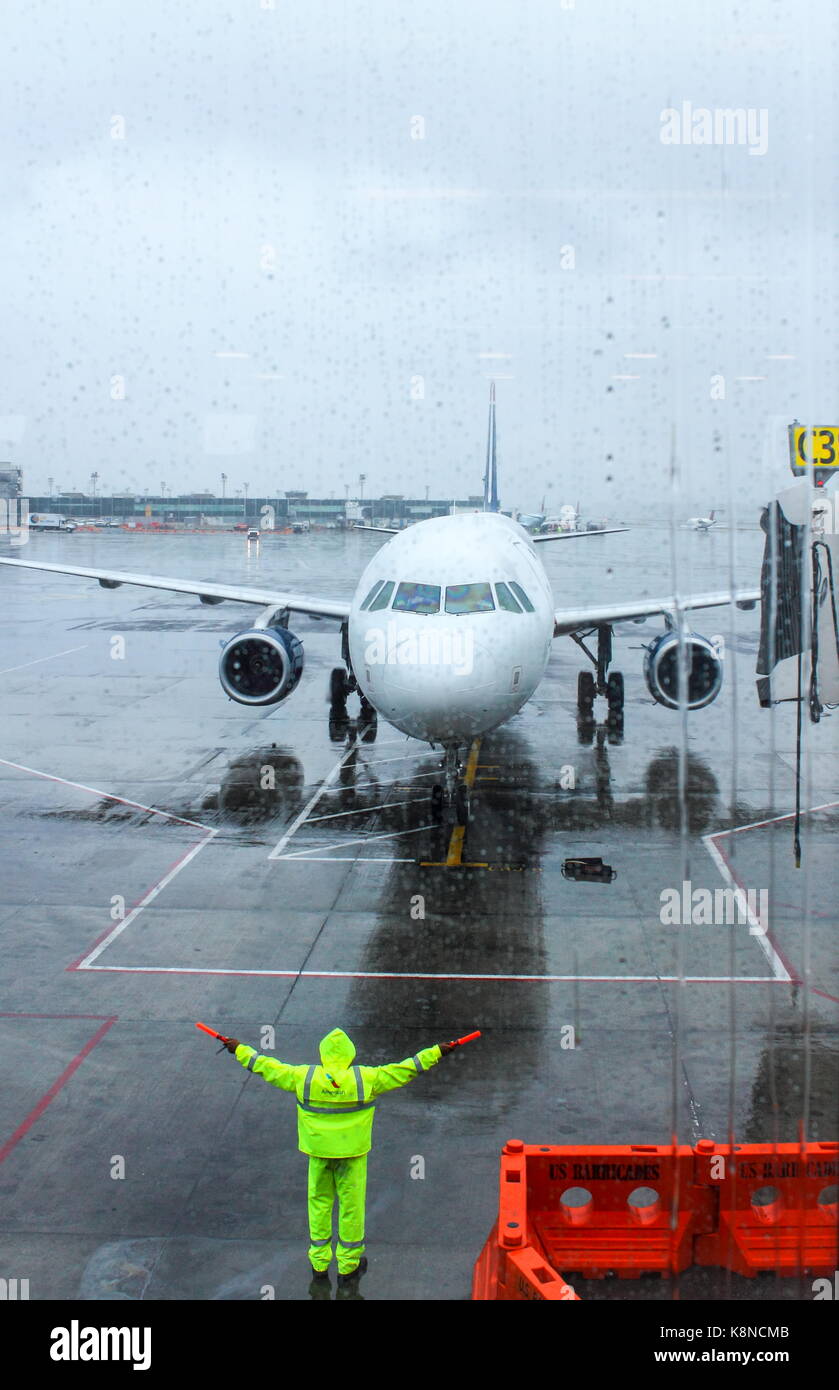 New York, USA - 30 September, 2016: Ground crew directing an incoming ...