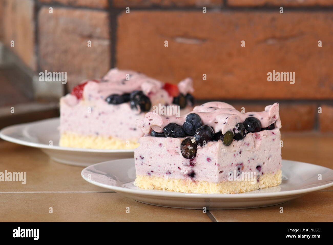 Cold cheesecake with blueberry and strawberry Stock Photo - Alamy