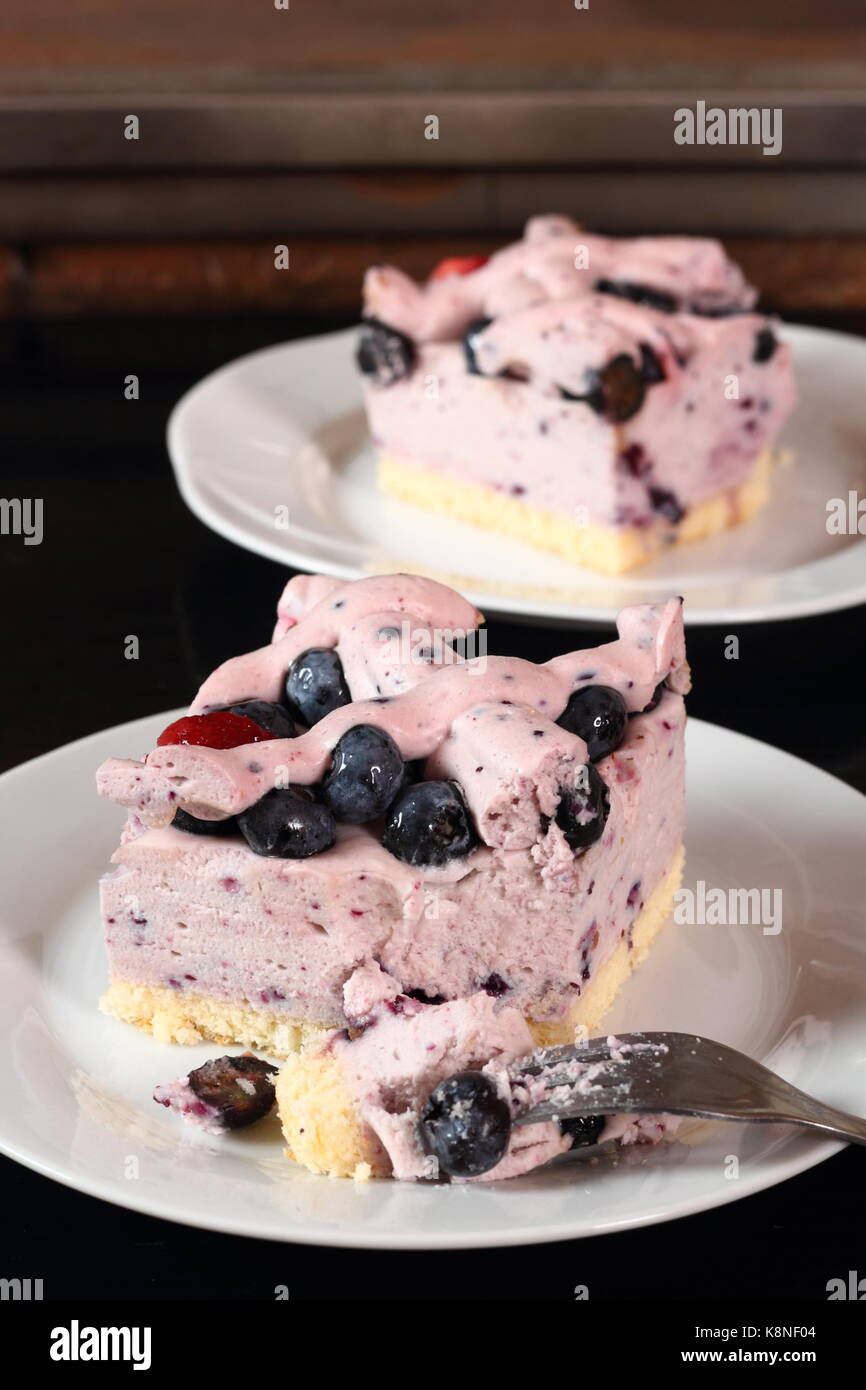 Cold cheesecake with blueberry and strawberry Stock Photo - Alamy