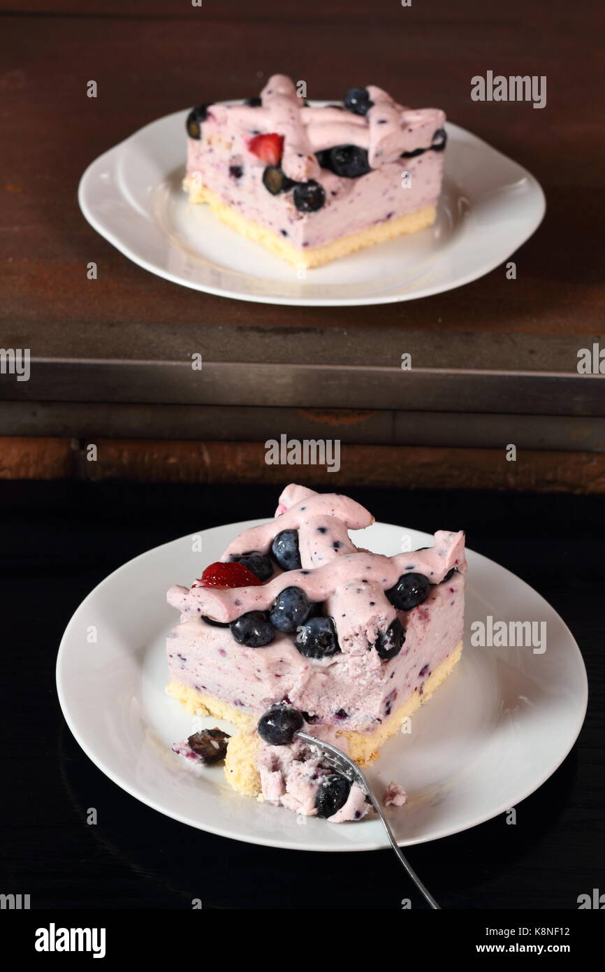 Cold cheesecake with blueberry and strawberry Stock Photo - Alamy