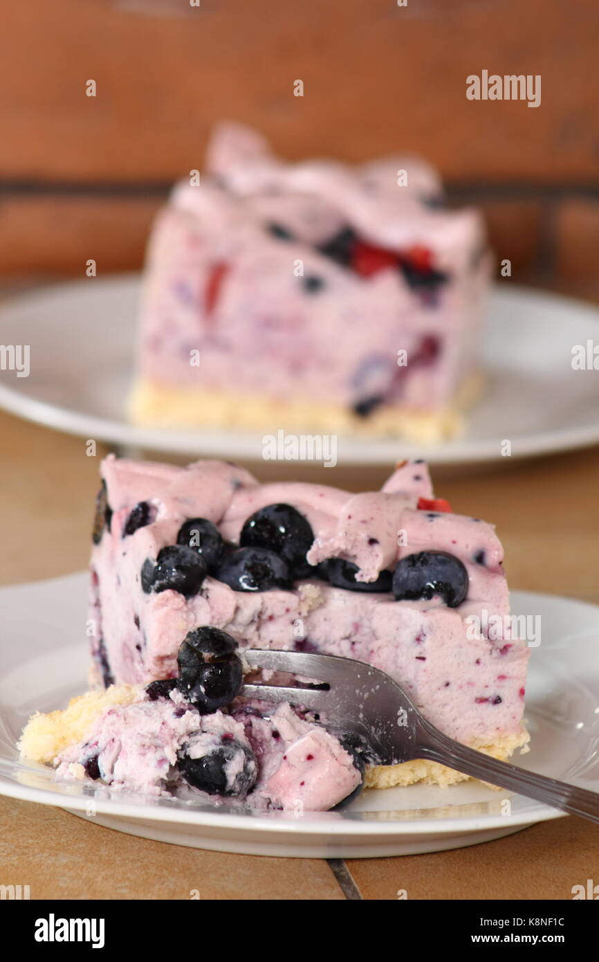 Cold cheesecake with blueberry and strawberry Stock Photo - Alamy