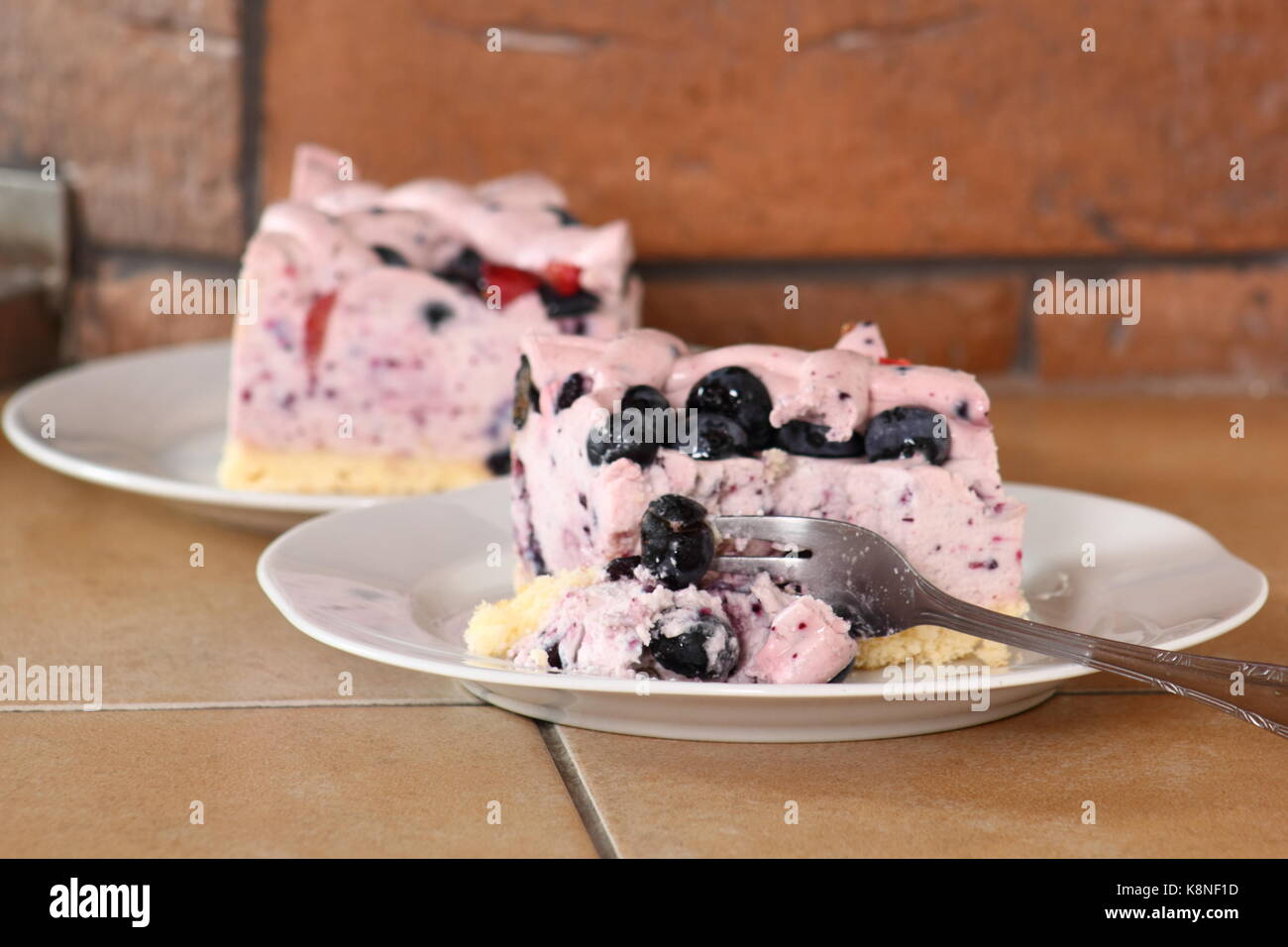 Cold cheesecake with blueberry and strawberry Stock Photo - Alamy
