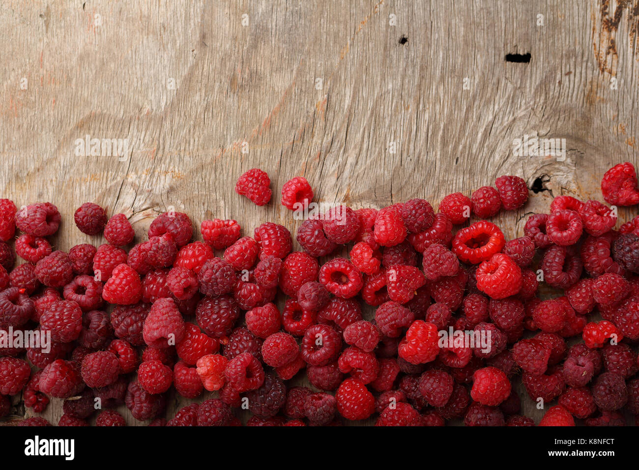 Wooden background with raspberry, copy-space Stock Photo - Alamy