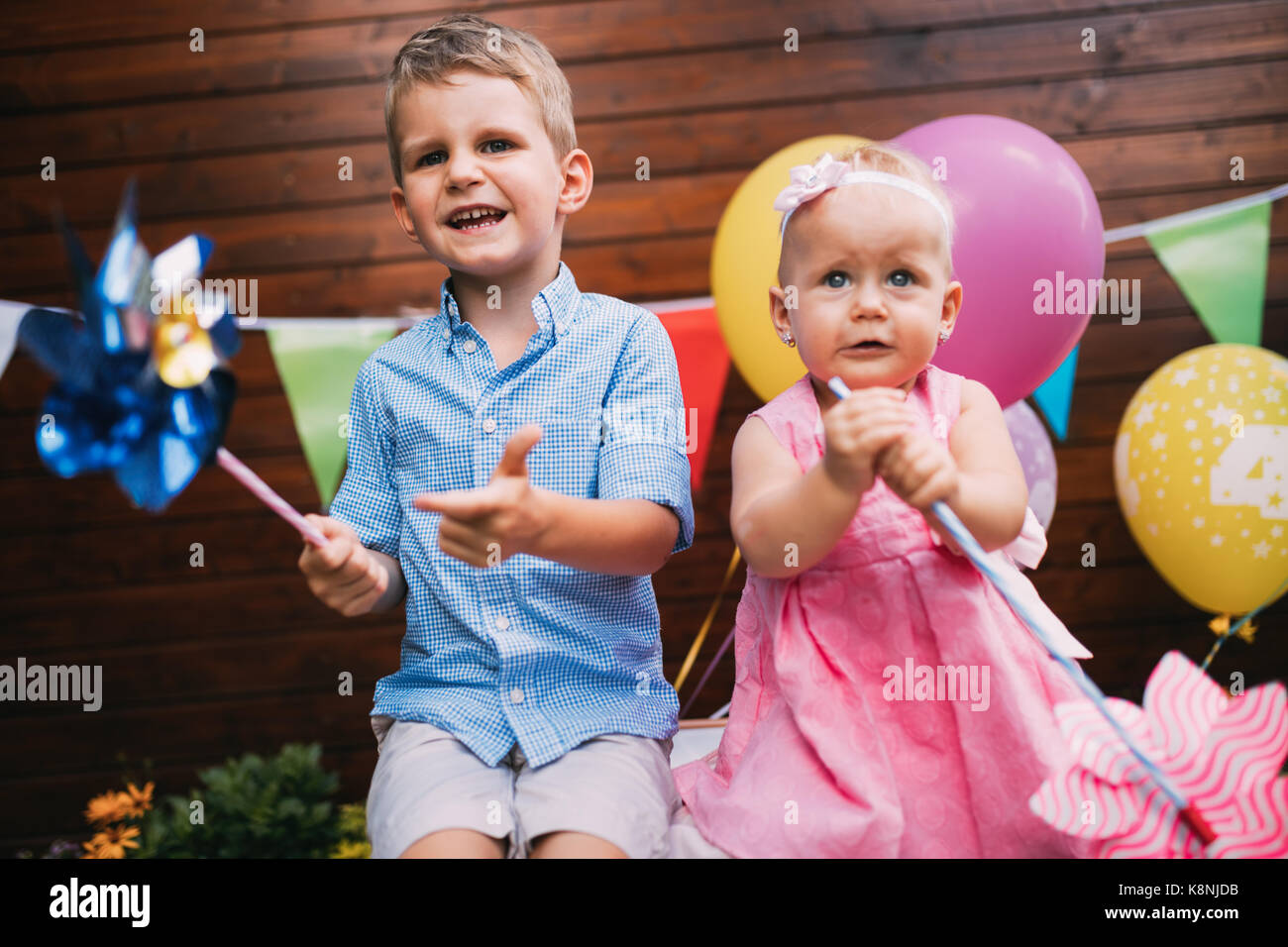 Happy young boy and little girl at birthday party Stock Photo - Alamy