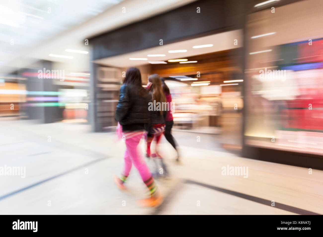 Shopper walking in front of shop window Stock Photo - Alamy