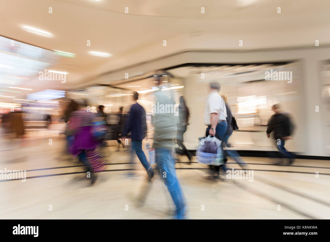 Shopper walking in front of shop window Stock Photo - Alamy