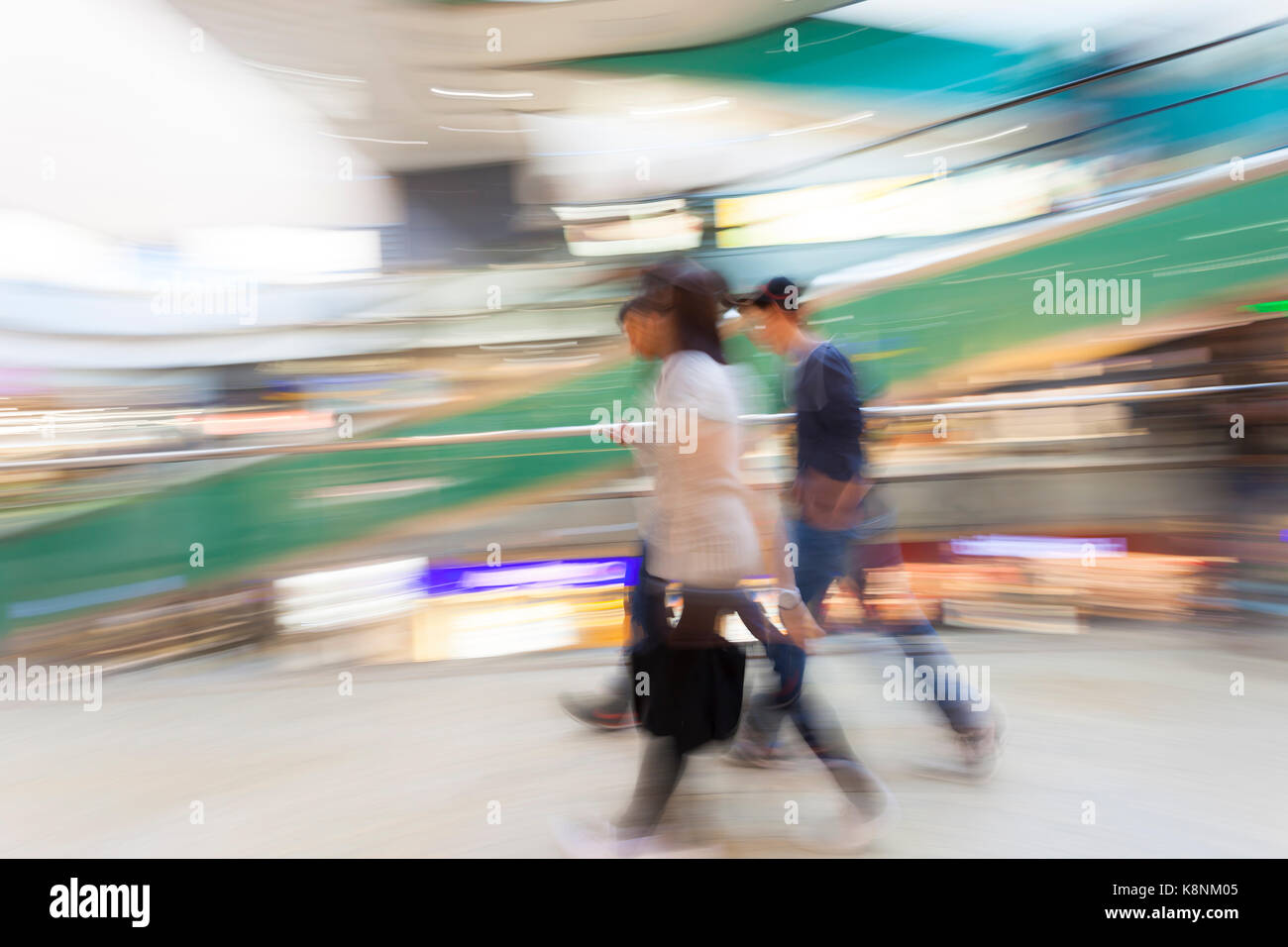 Shopper walking in front of shop window Stock Photo - Alamy
