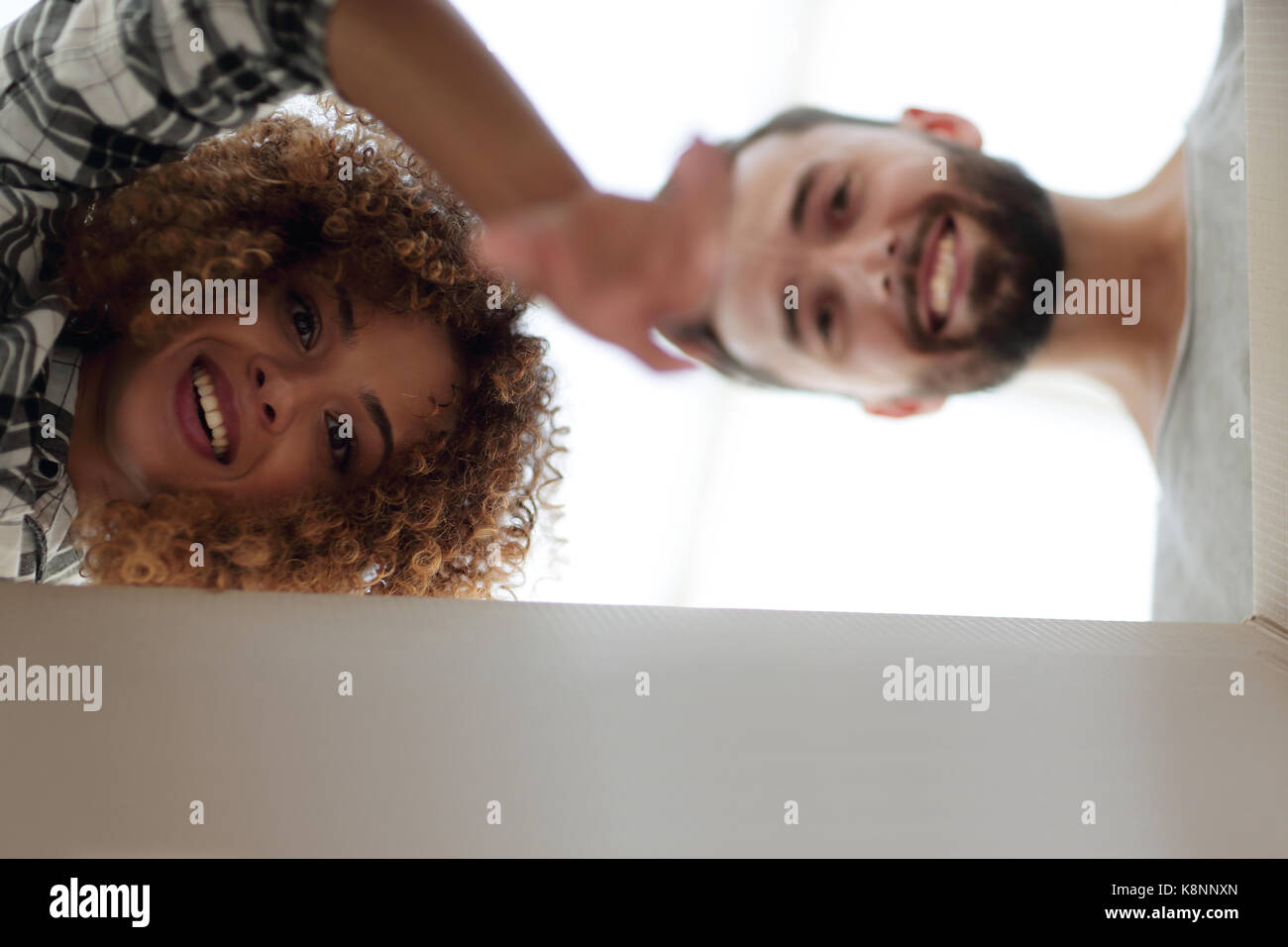 View from below husband and wife looking inside the box Stock Photo - Alamy