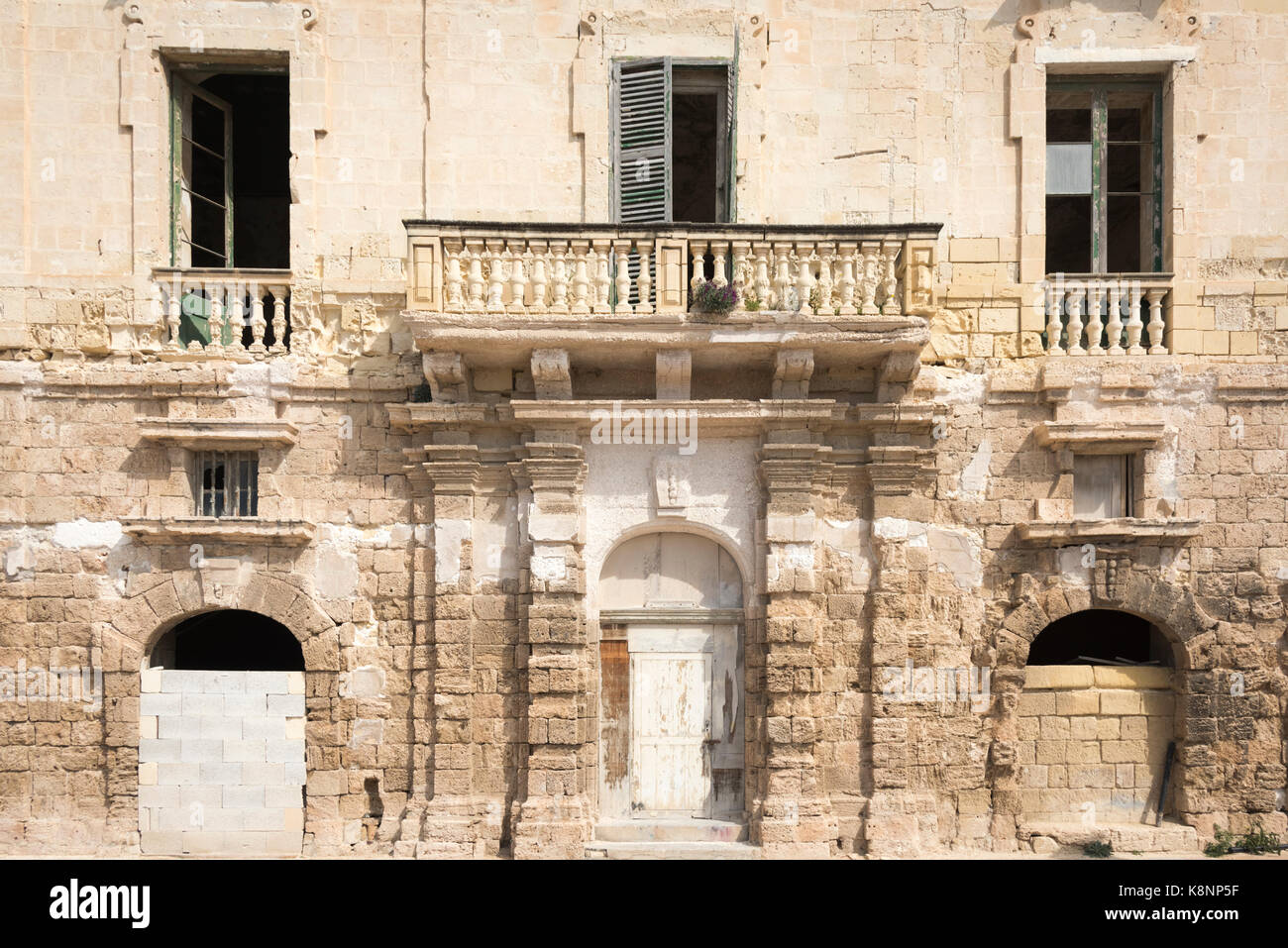 A crumbling old stone building with a Maltese balcony in Malta Stock ...