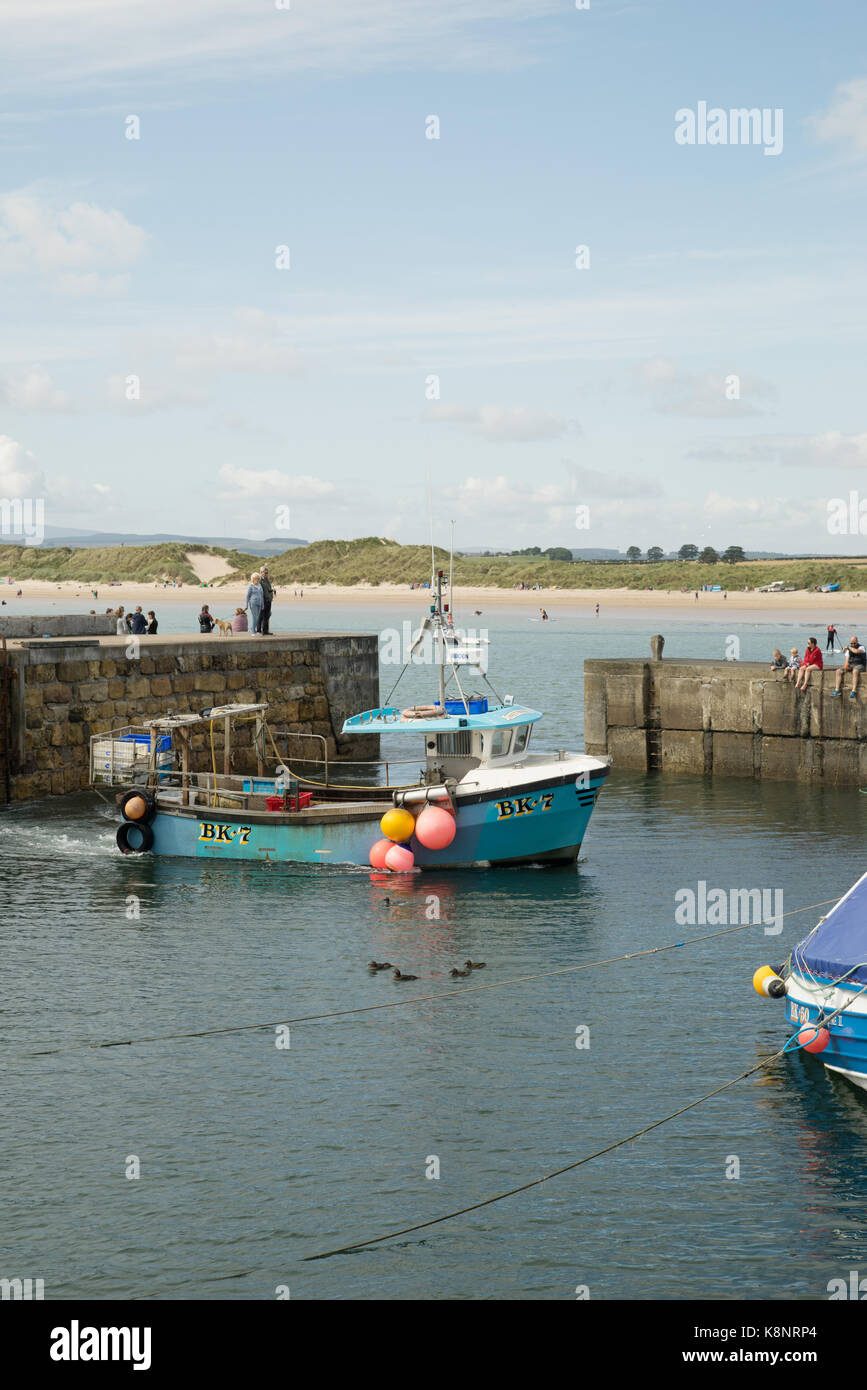 Fishing boat returns to Beadnell Harbour, Northumberland, England Stock ...