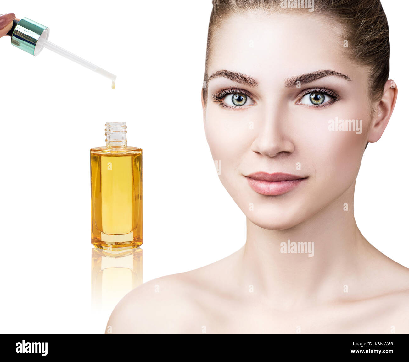 Cosmetic oil applying on face of young woman Stock Photo - Alamy
