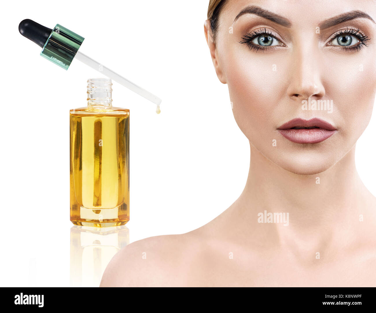 Cosmetic oil applying on face of young woman Stock Photo - Alamy