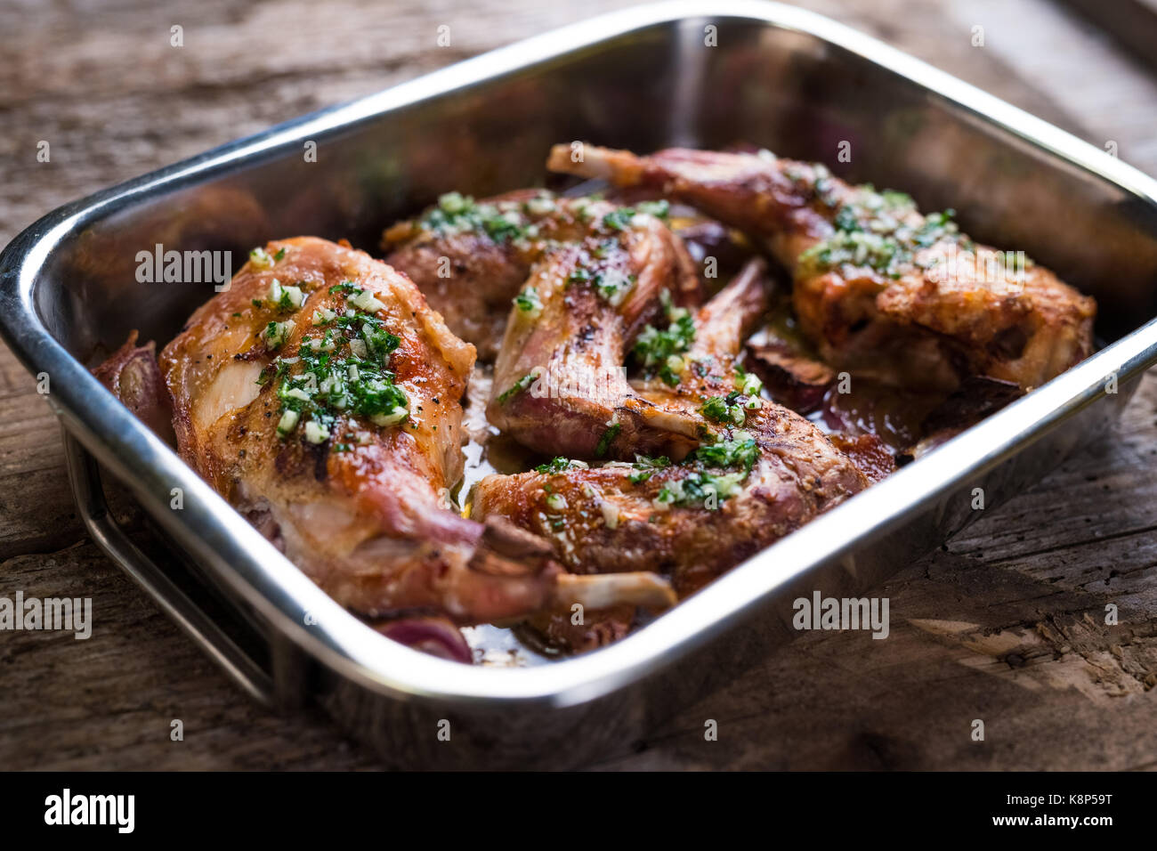 Roasted rabbit leg Stock Photo - Alamy