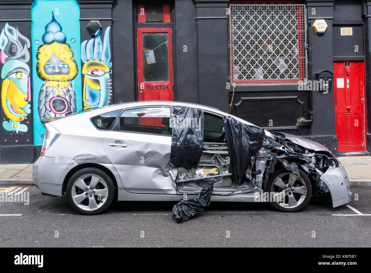 Damaged car left at side of city road after traffic accident Stock ...