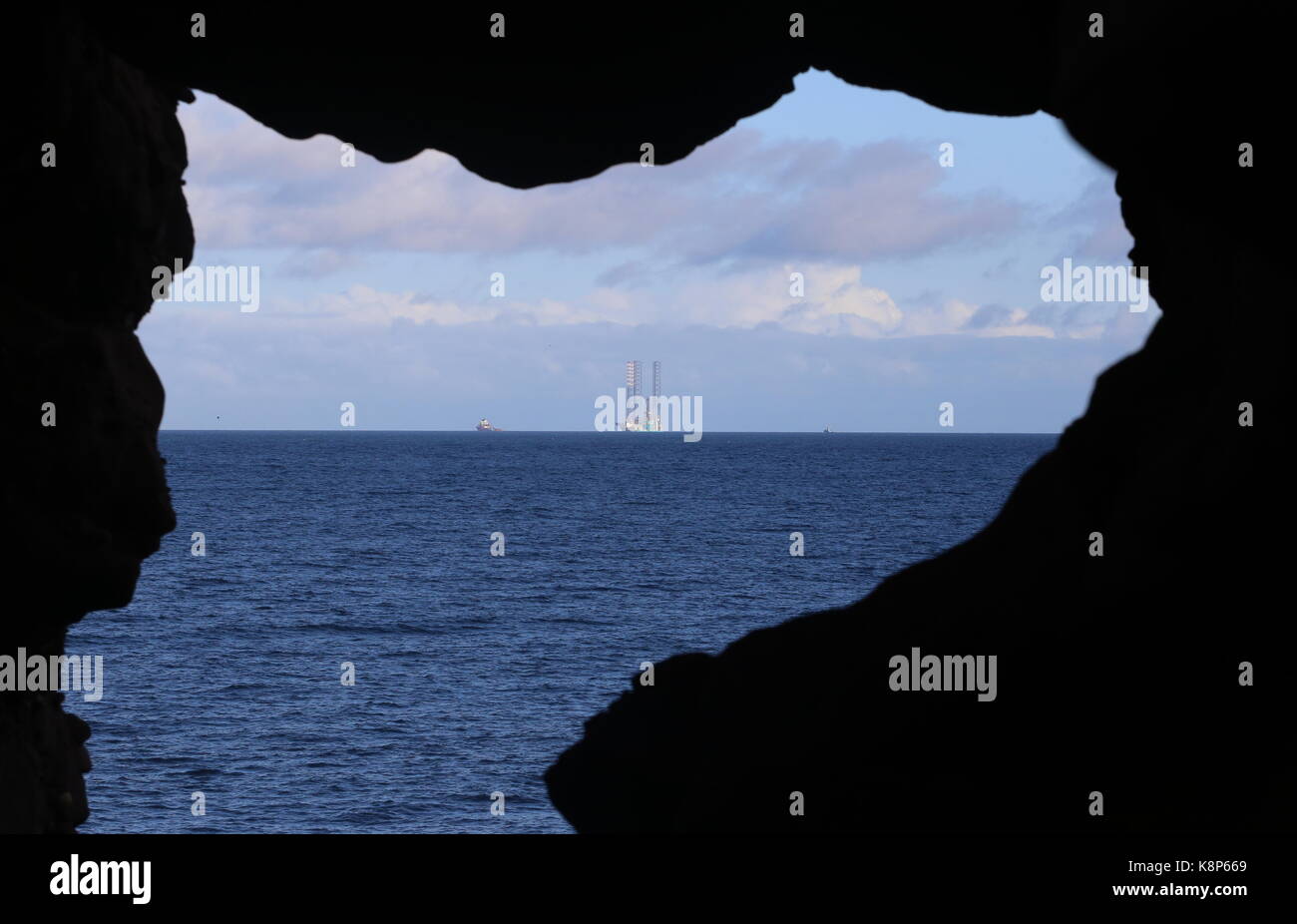 Oil Rig Rowan Stravanger under tow viewed through Needles Eye rock arch ...