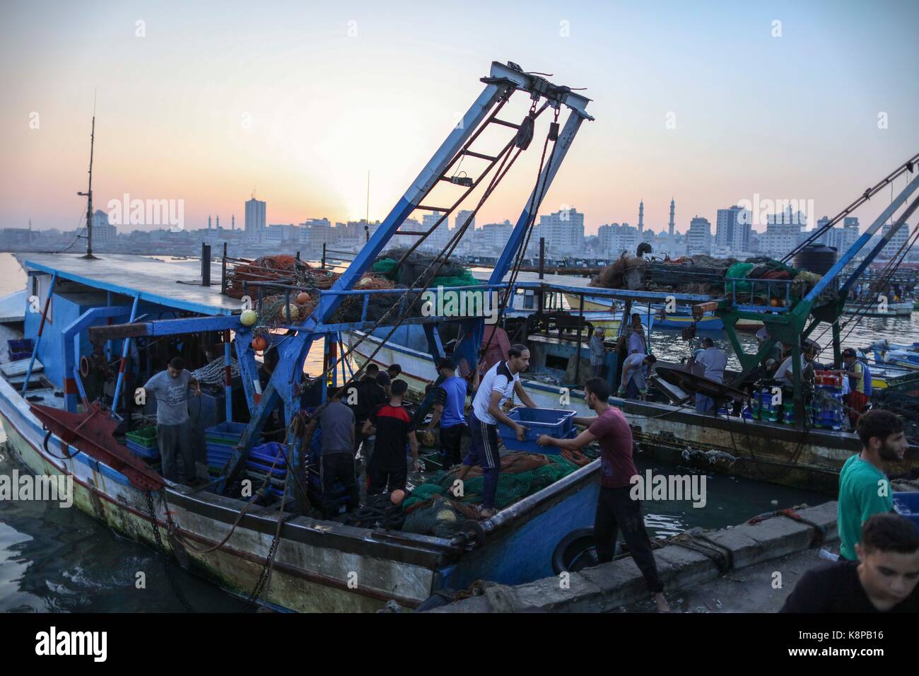 Gaza. 20th Sep, 2017. Palestinian fishermen work on their fishing boat ...