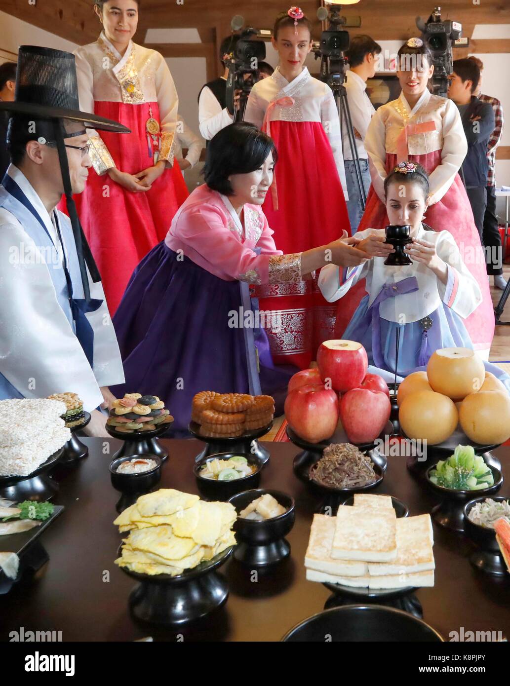 Foreigners experience traditional ritual A woman, a member of an ...