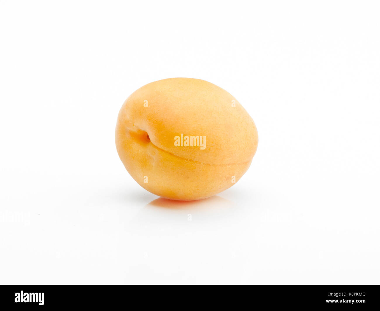 A single Apricot on a white background Stock Photo - Alamy