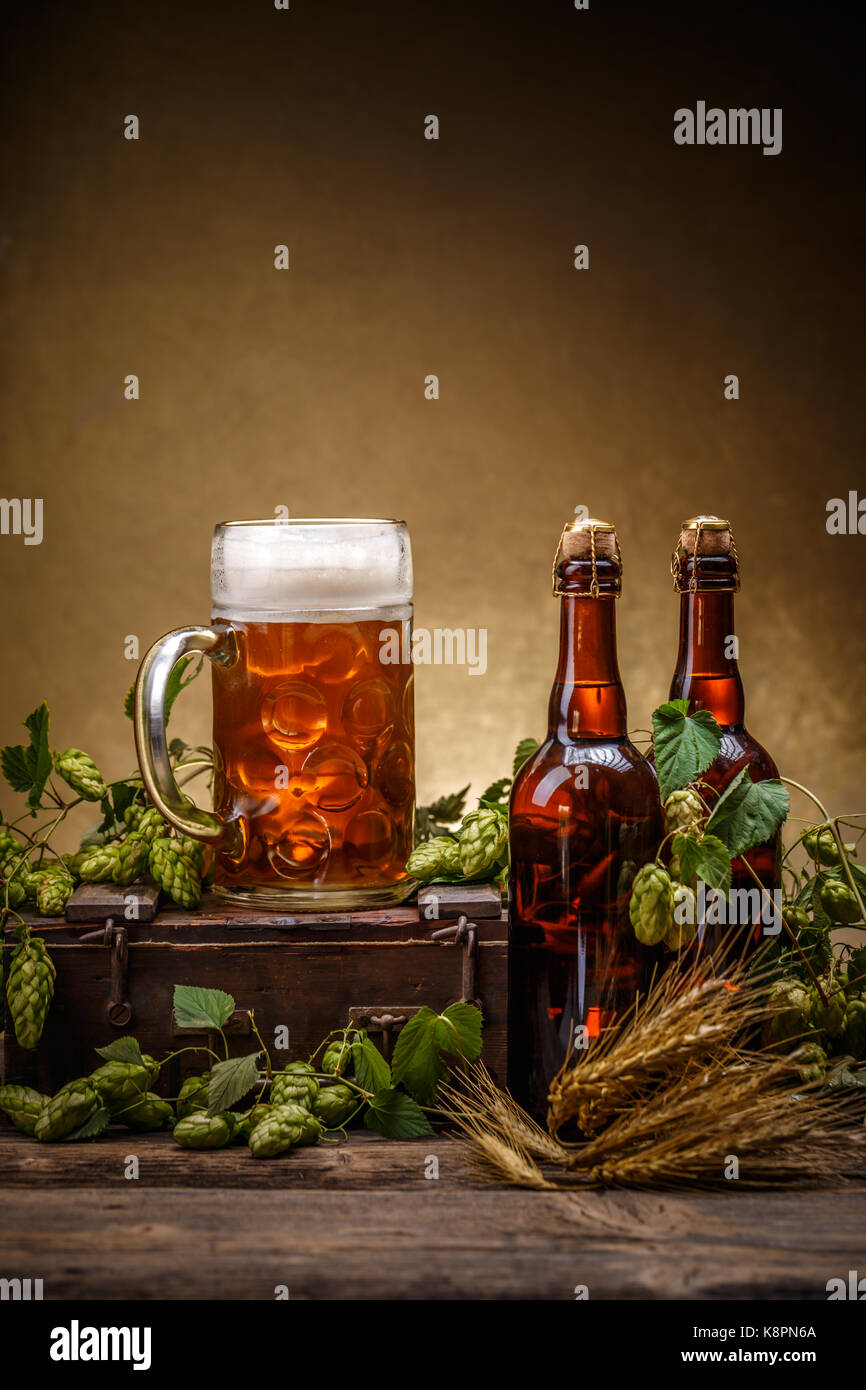 Beer with brewery hop on rustic style background Stock Photo - Alamy