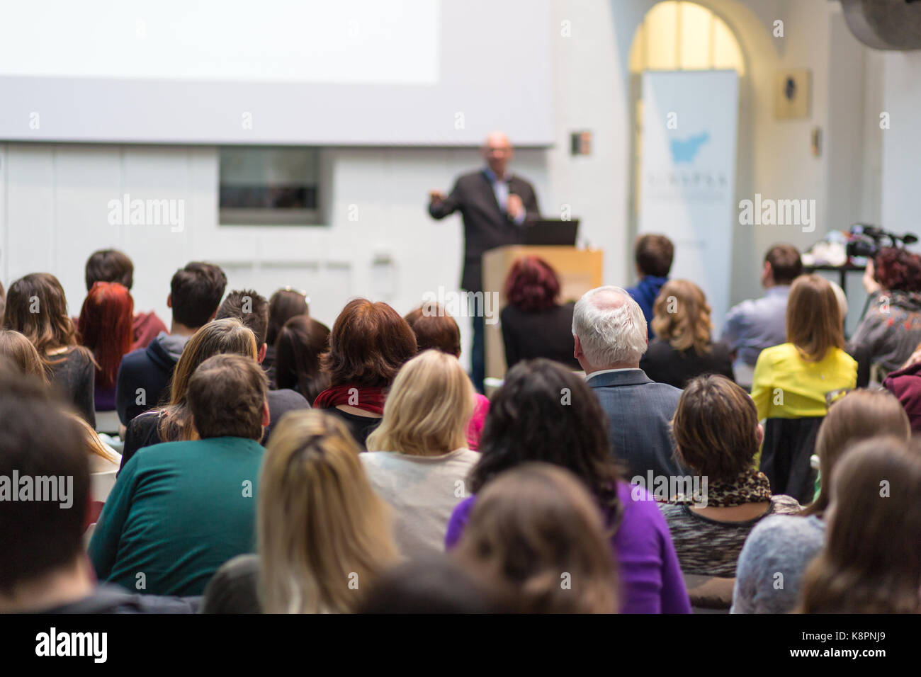 Man giving presentation in lecture hall at university Stock Photo - Alamy