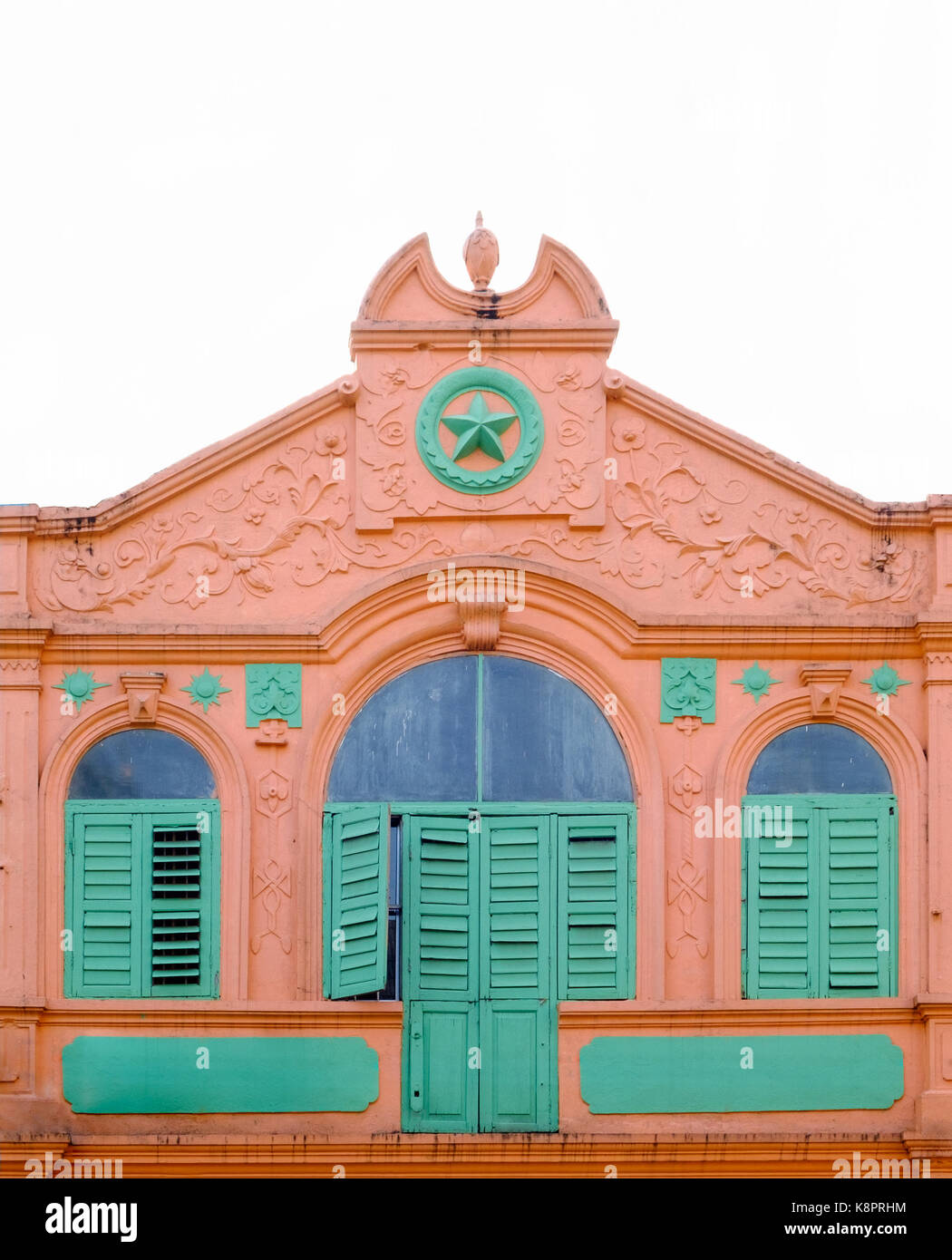 Old window on orange buildings in the south of Thailand. Sino ...