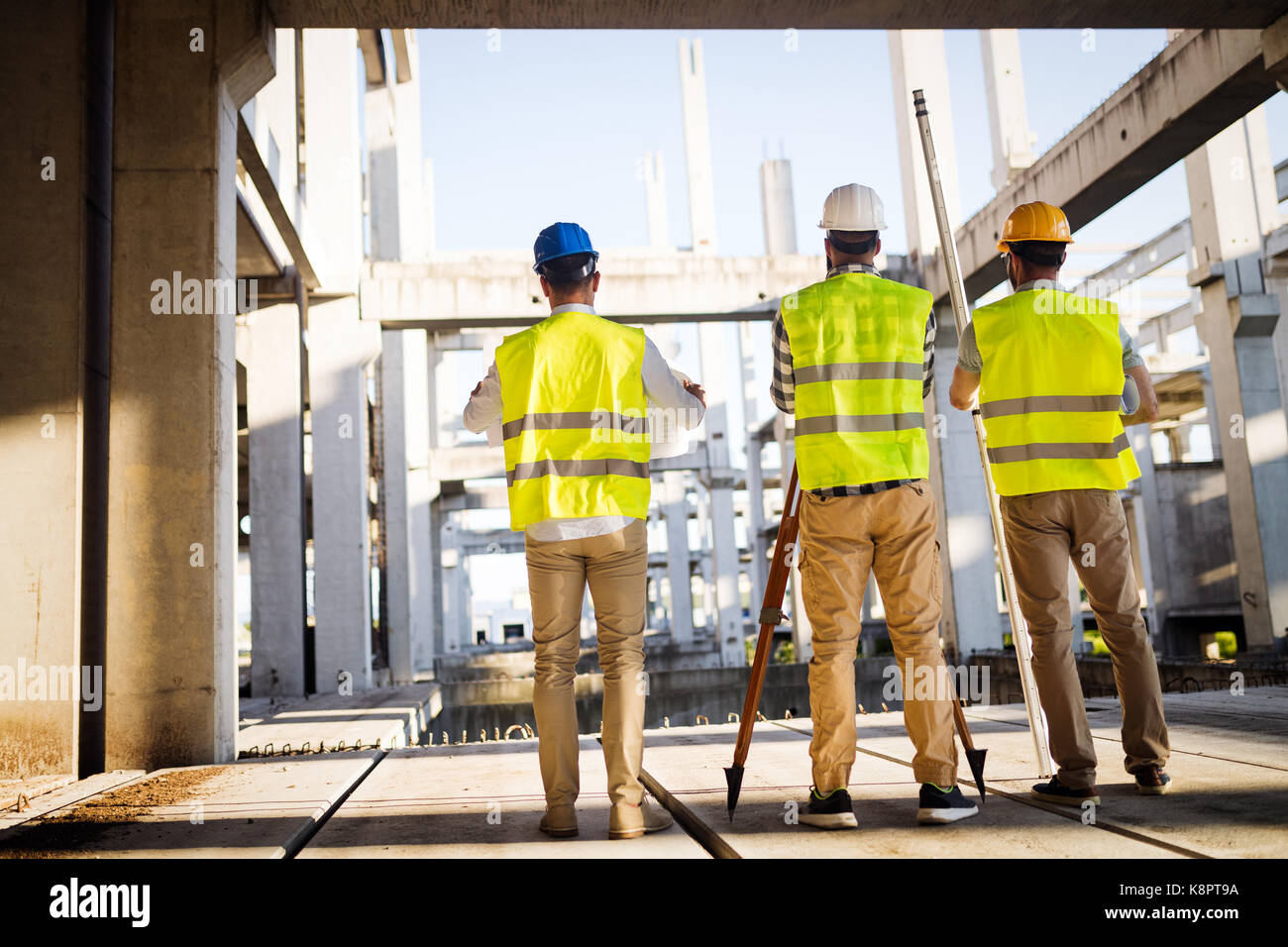 Team of construction engineers working on building site Stock Photo - Alamy