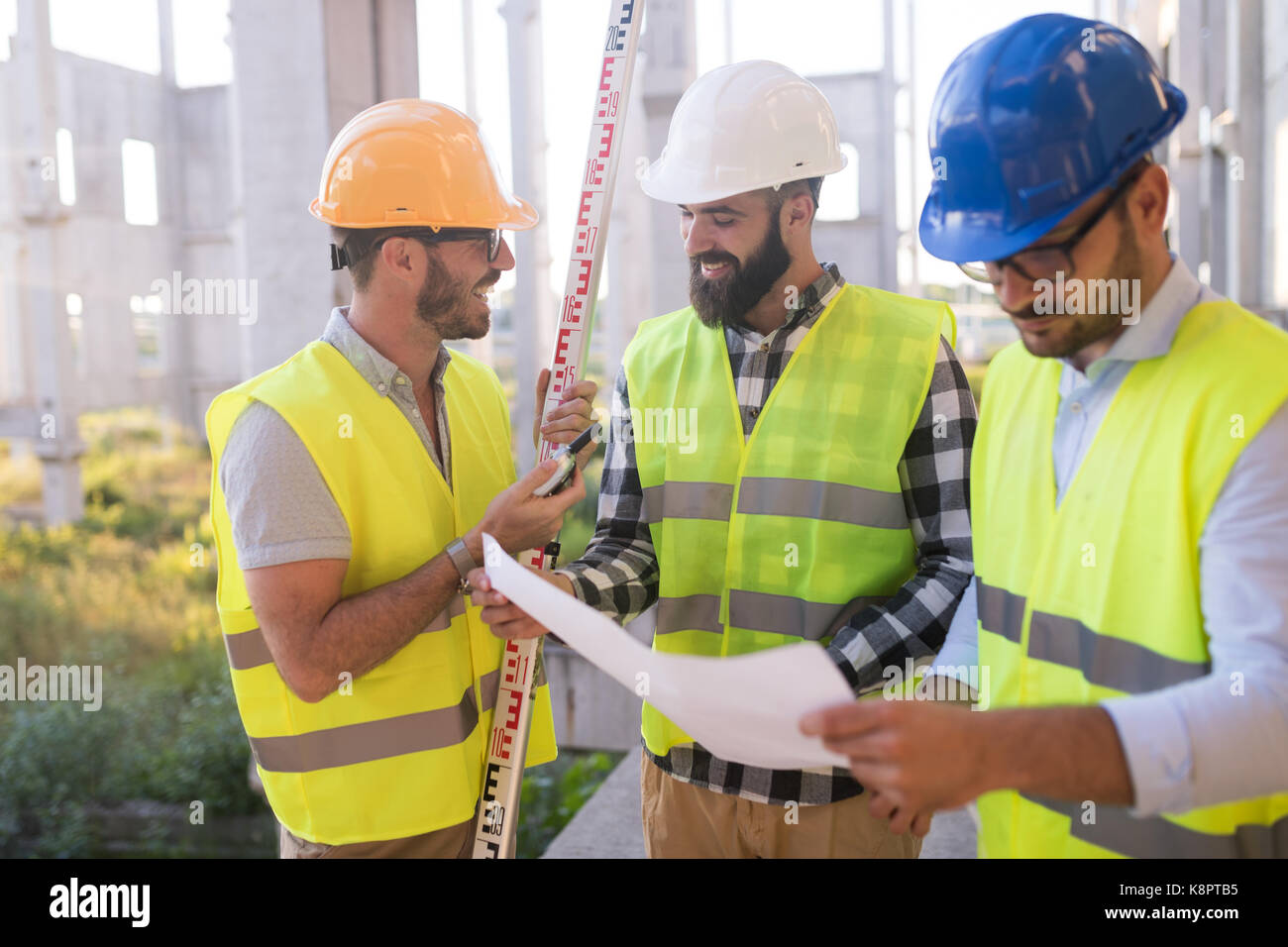 Portrait of construction engineers working on building site Stock Photo ...