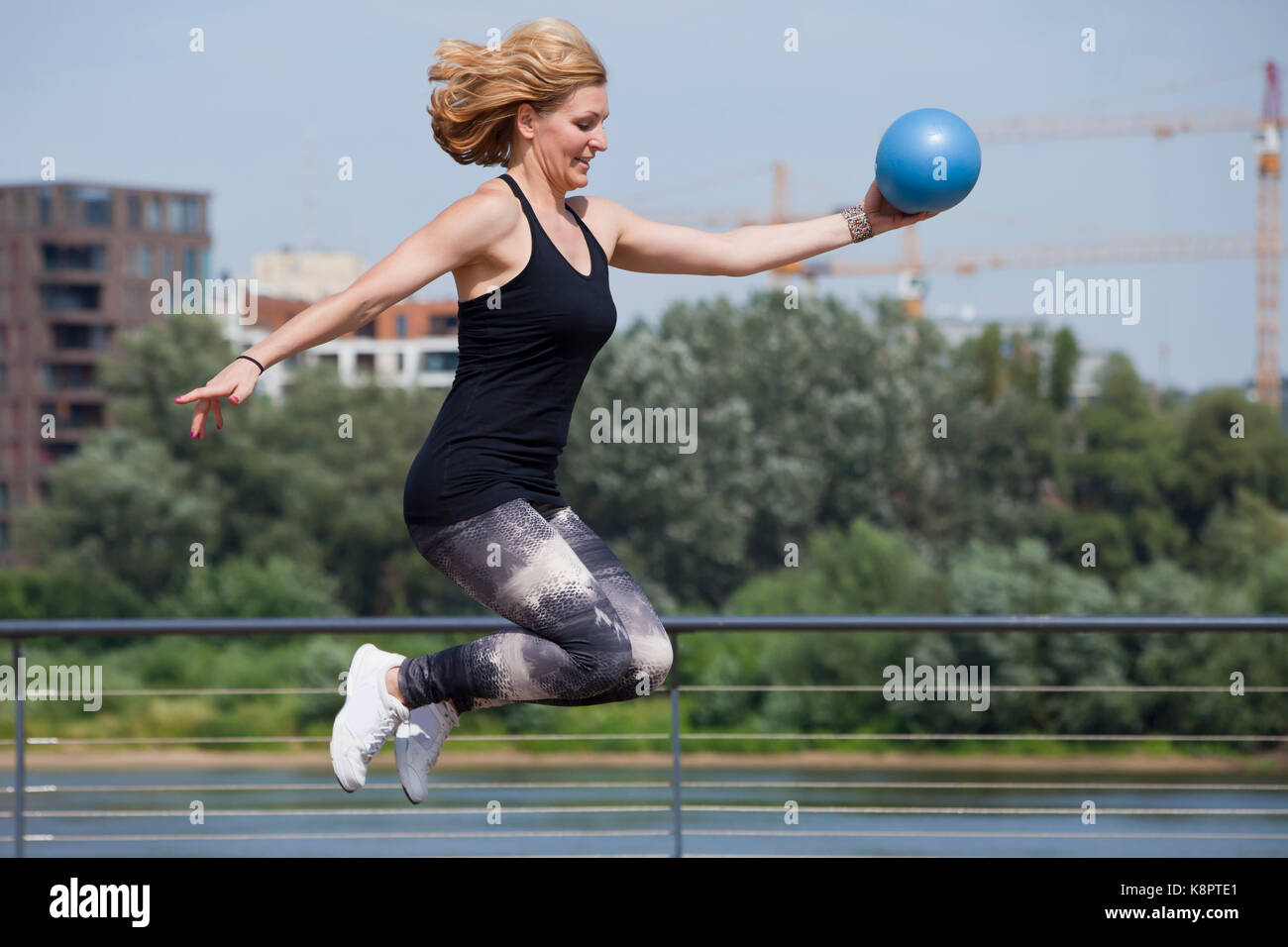 Woman doing outdoor workout in the city Stock Photo - Alamy