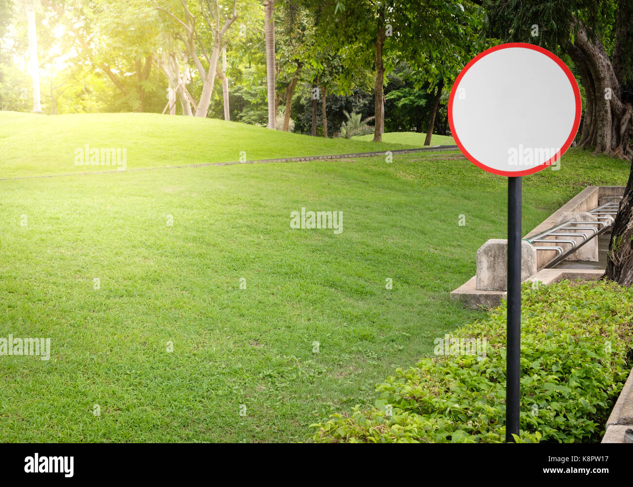 White blank circle sign board in the green park in the evening there is ...