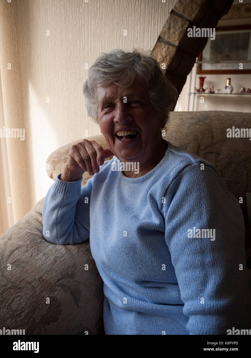 A single senior woman displays happiness by laughing Stock Photo - Alamy