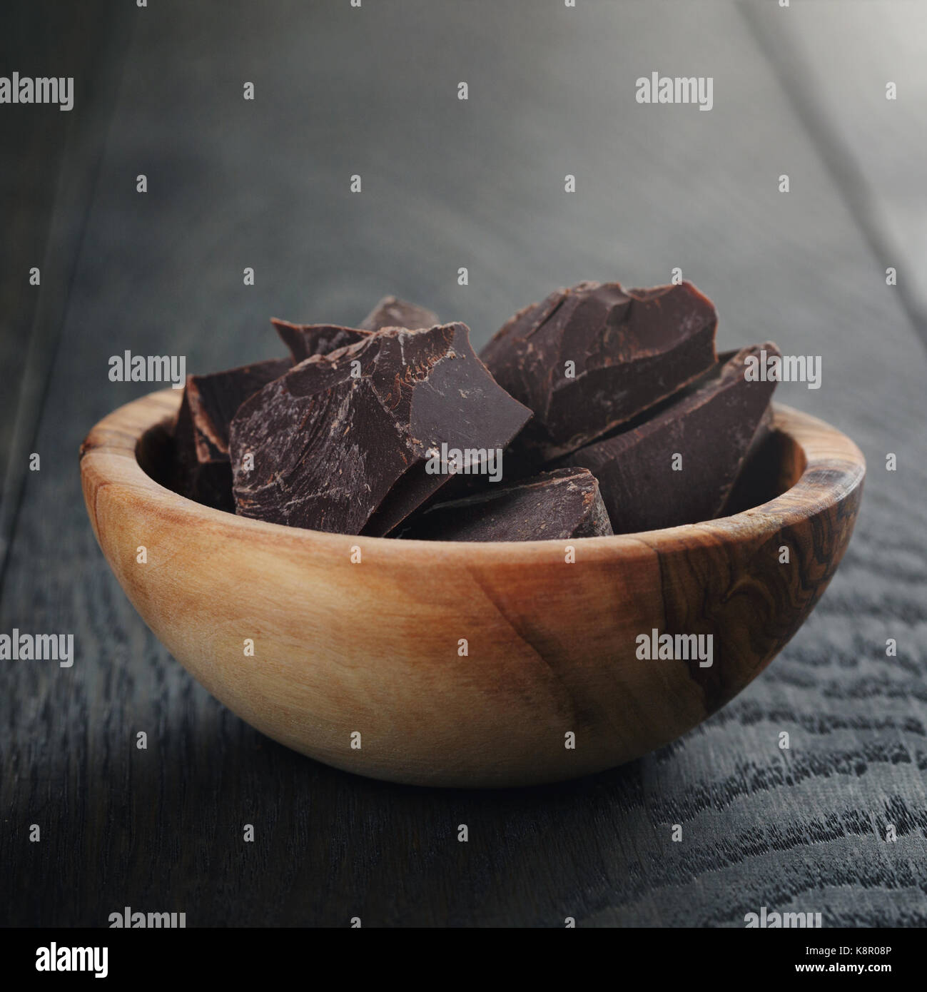 dark chocolate chunks in wooden bowl Stock Photo - Alamy