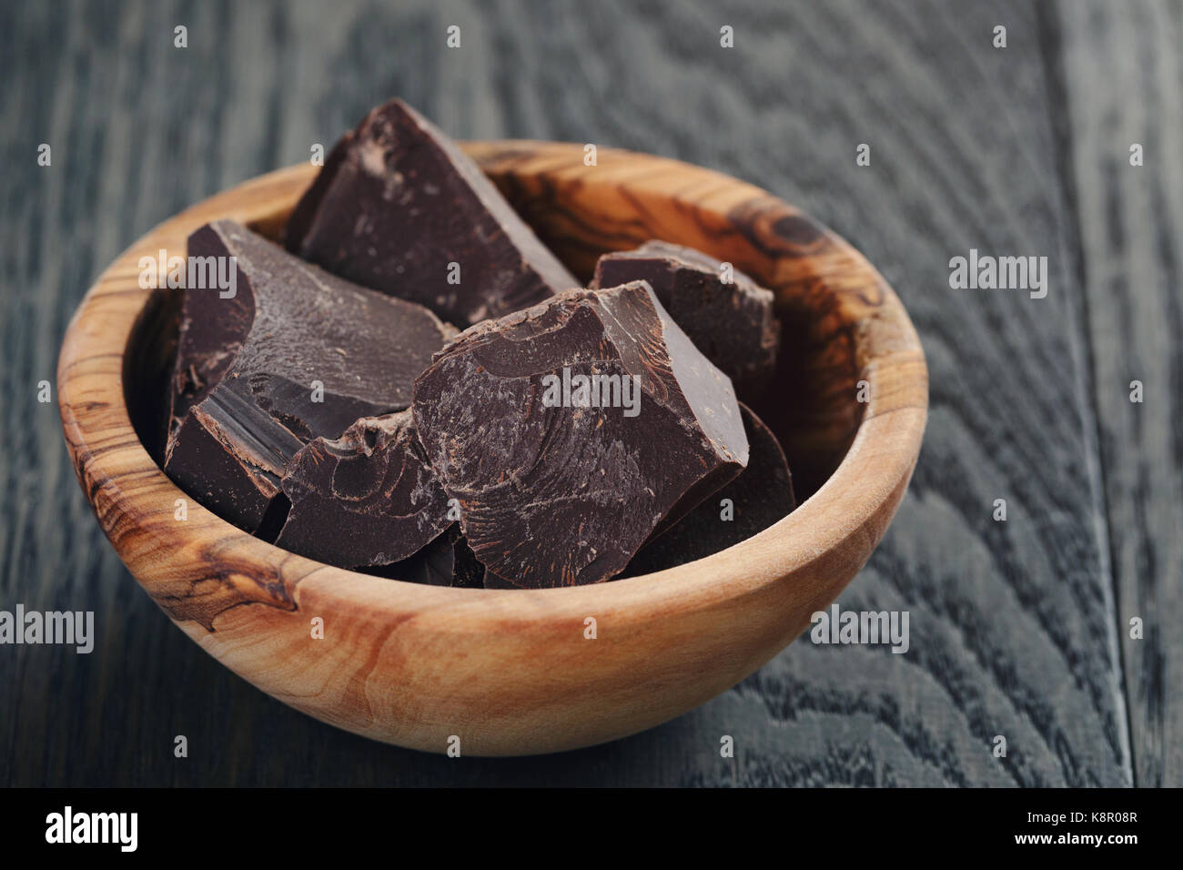 dark chocolate chunks in wooden bowl Stock Photo - Alamy