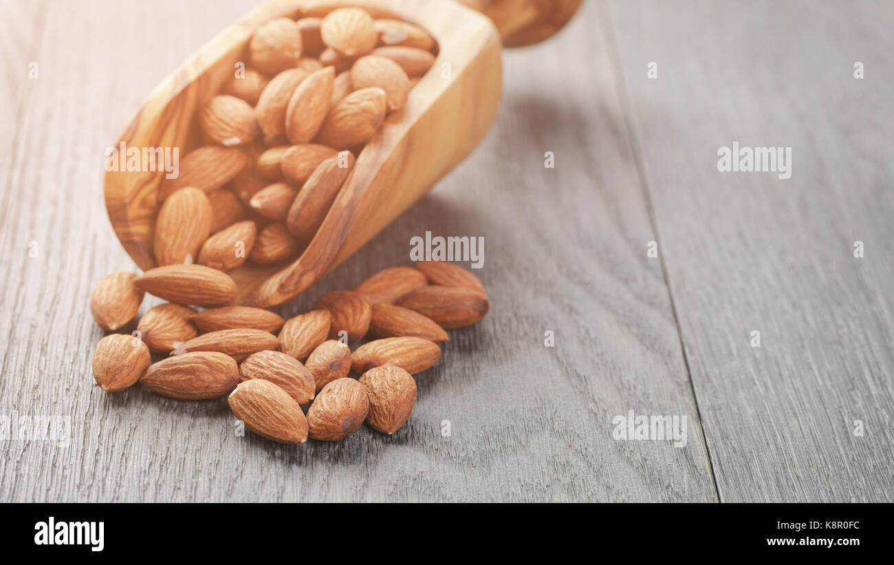 roasted almonds on gray wooden table Stock Photo - Alamy