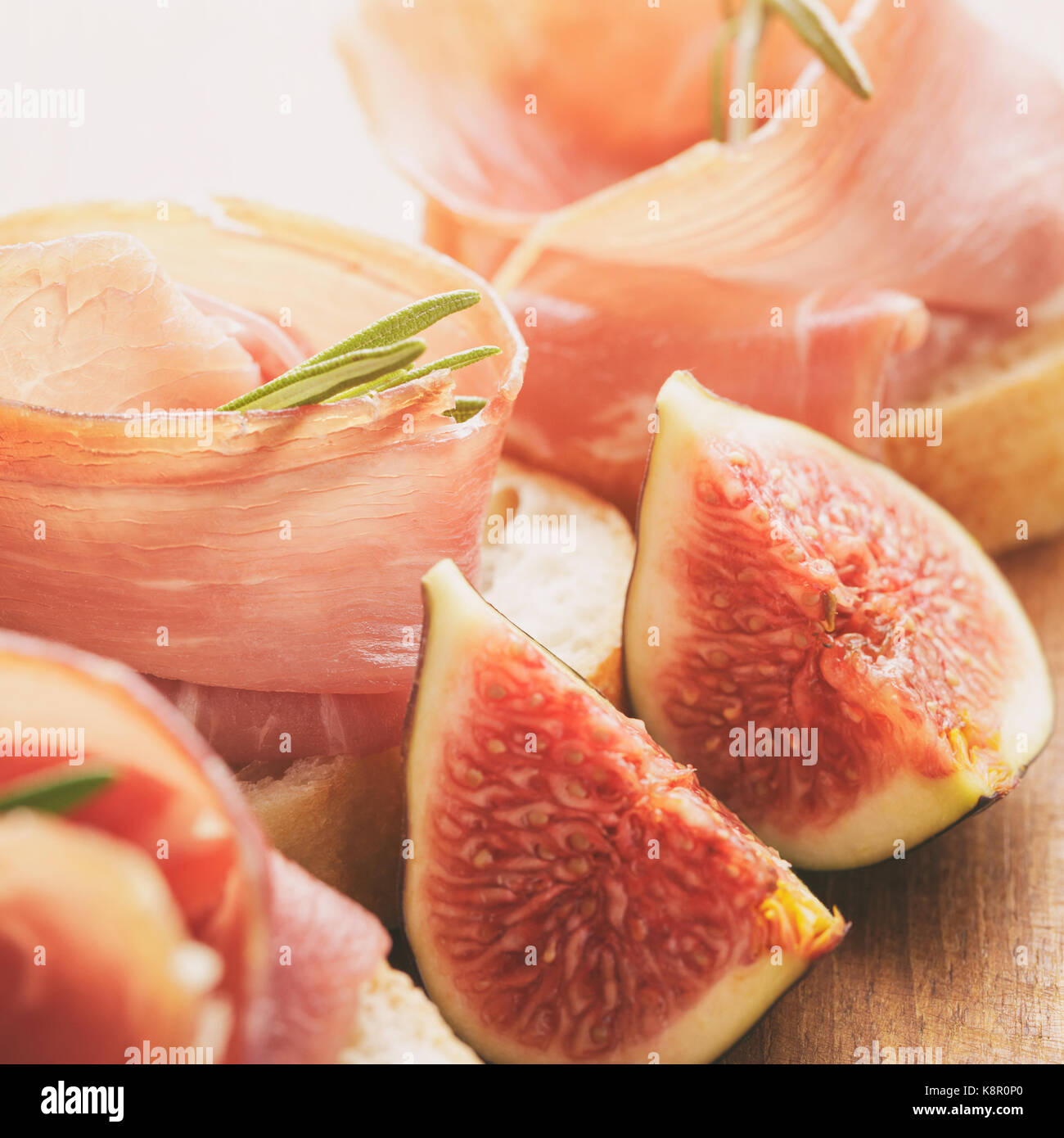 canapes with jamon and figs on wooden board Stock Photo - Alamy