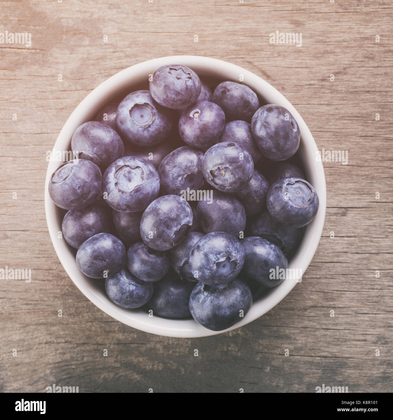 fresh blueberries in white bowl on wood table Stock Photo - Alamy