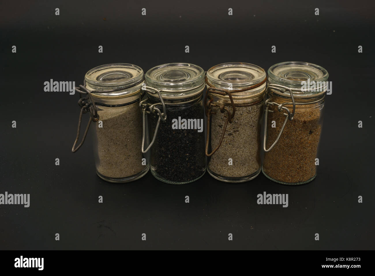 different sand in glass bottles Stock Photo - Alamy