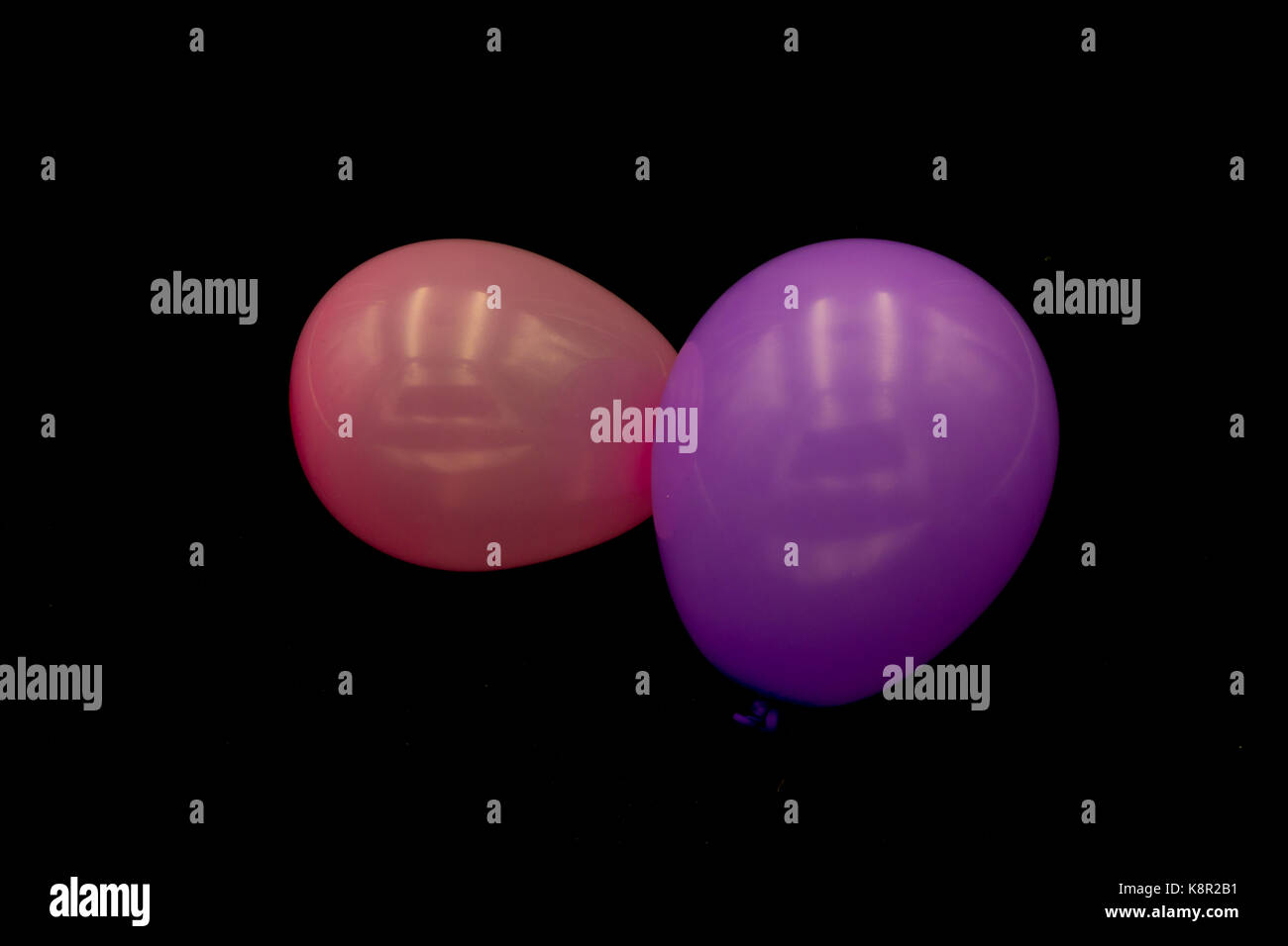 two small Balloon on black background Stock Photo - Alamy