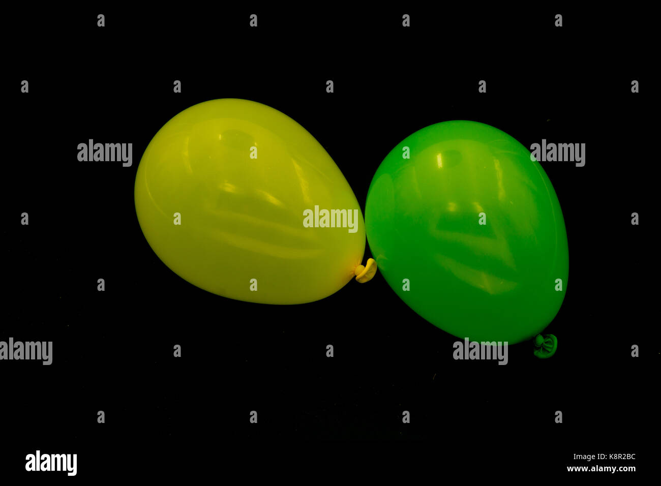 two small Balloon on black background Stock Photo - Alamy