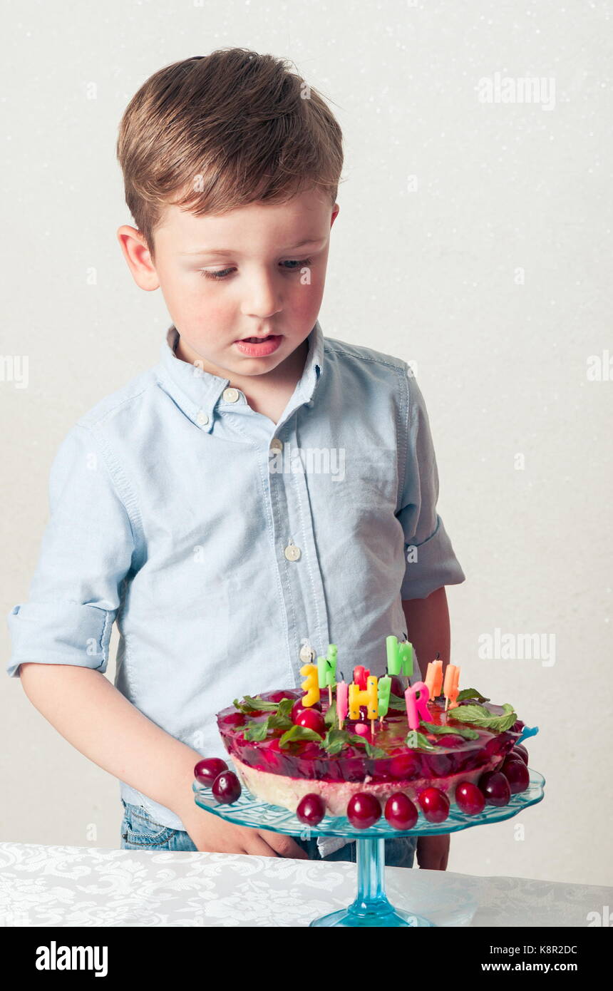 Little boy with the birthday cake Stock Photo - Alamy