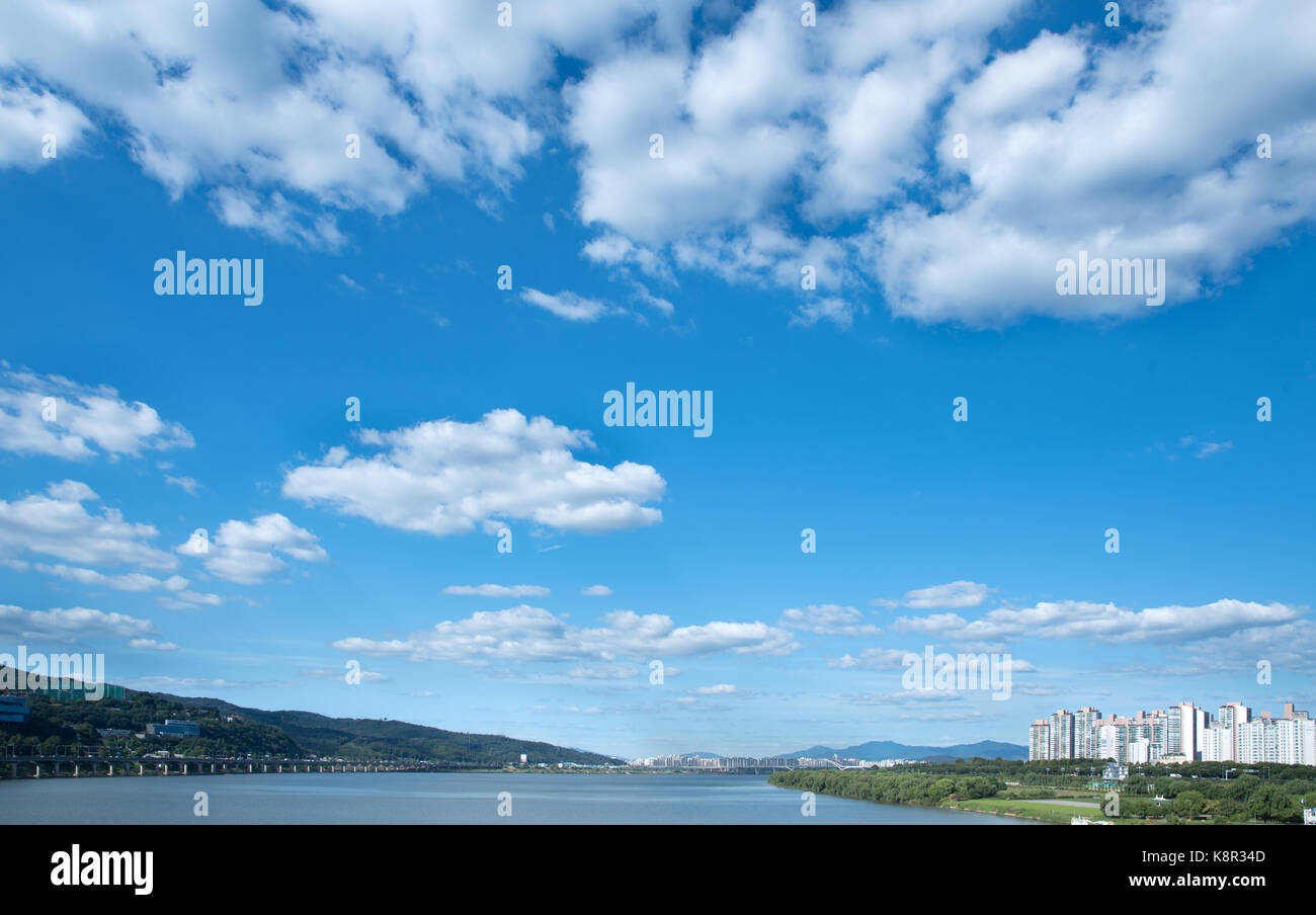 Blue sky with river and town Stock Photo - Alamy