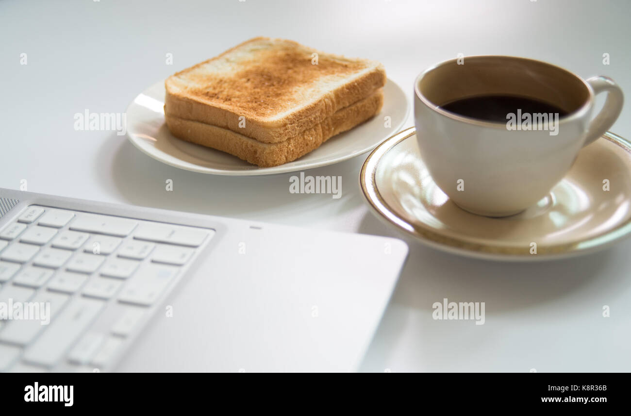 Laptop and Cup of coffee with toast, Business concept Stock Photo - Alamy