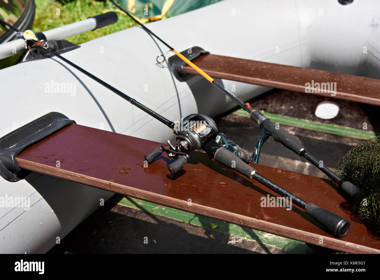 Spinning reel for fishing on inflatable rubber boat Stock Photo - Alamy