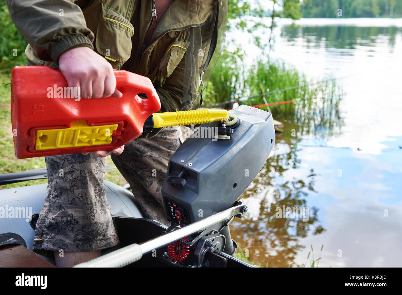 Fisherman pours gasoline into the engine of a fishing boat Stock Photo ...