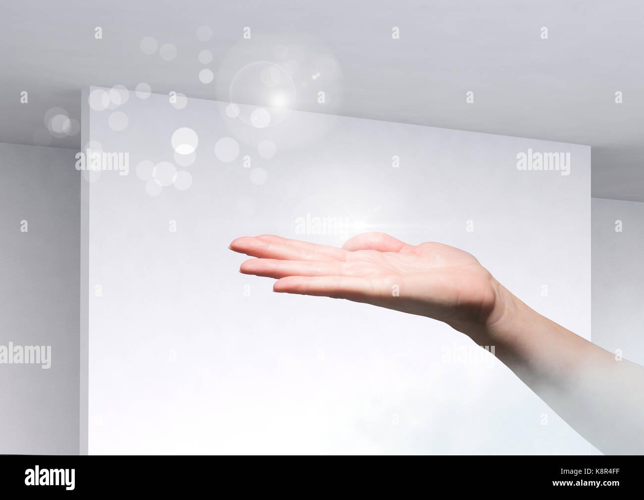 Digital composite of Open hand with bright background Stock Photo - Alamy