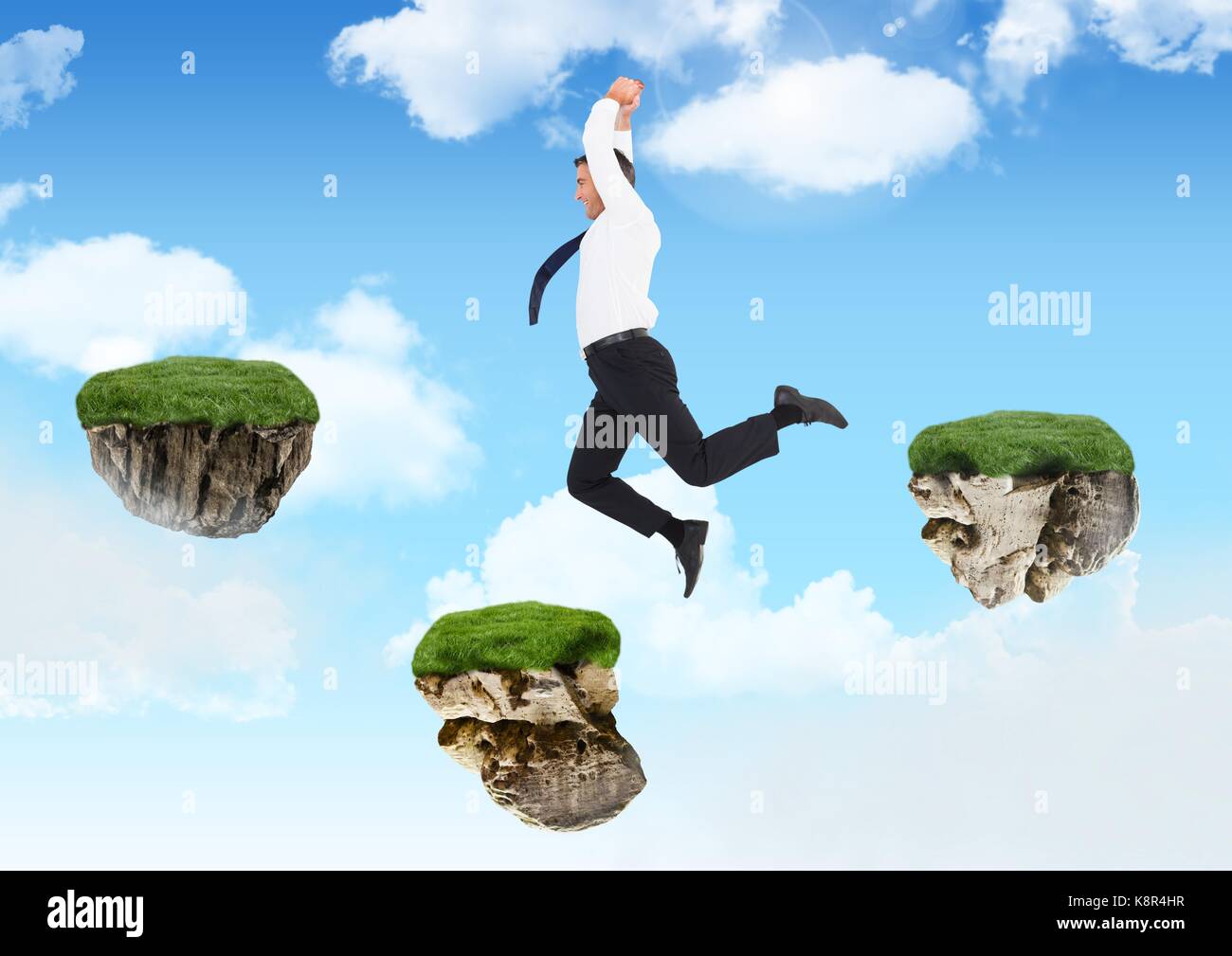Digital composite of Businessman jumping between steps of floating rock ...