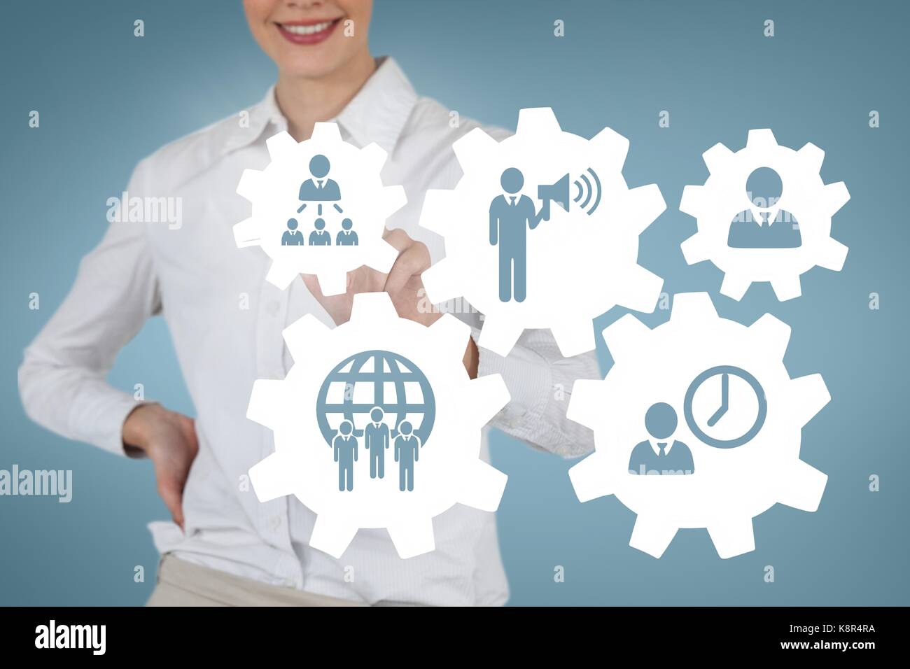 Digital composite of Business woman interacting with people in cogs ...