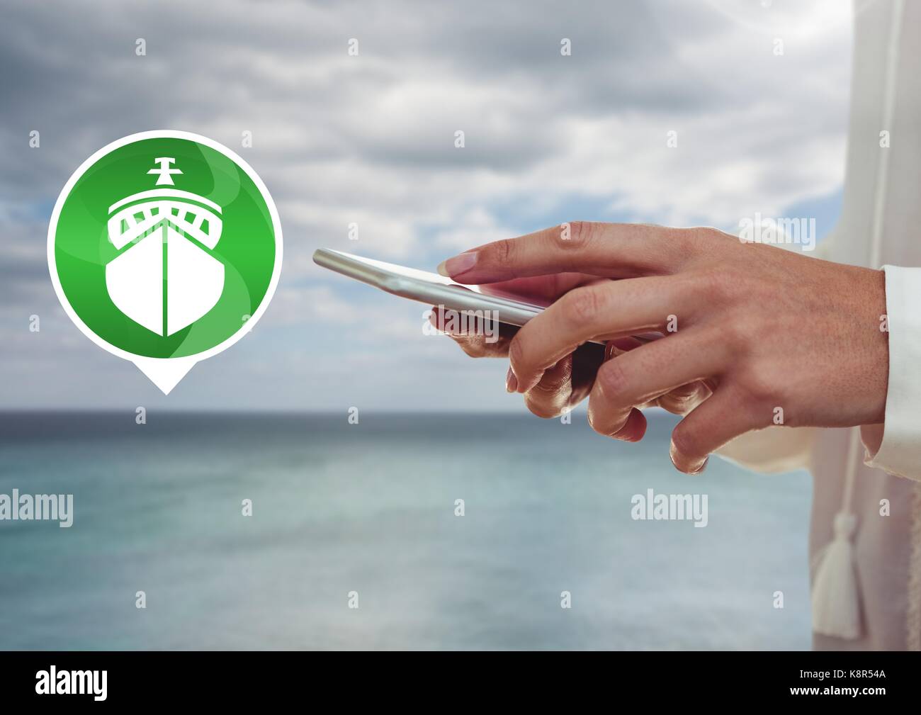 Digital composite of Hand holding phone with ship icon by sea Stock ...